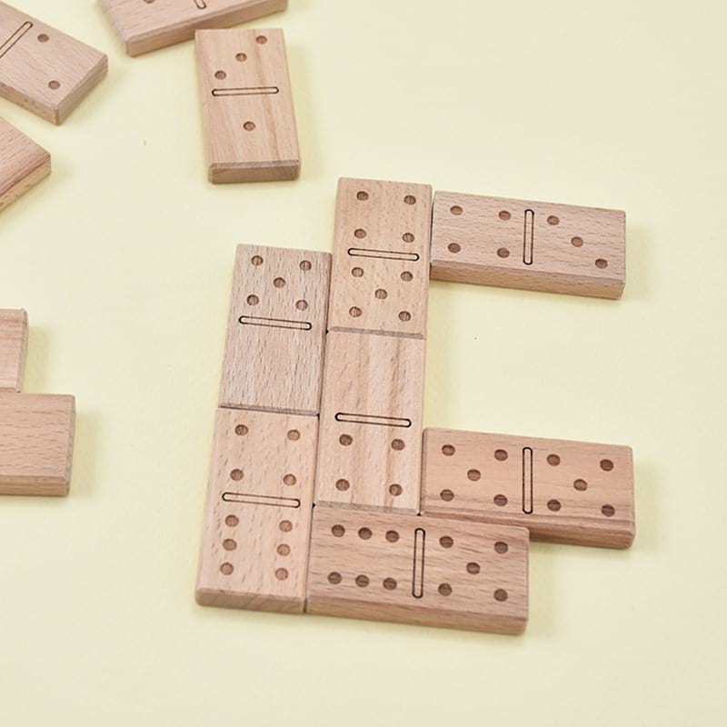 Wooden domino with engraved spots in cotton bag